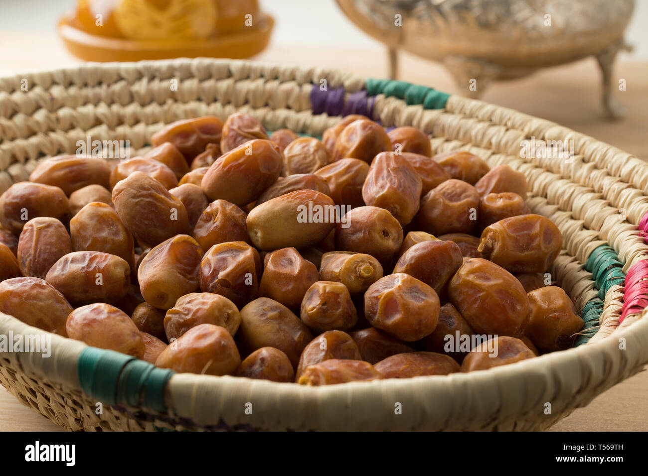 Basket with dried Iranian Zahedi dates isolated on white background ...