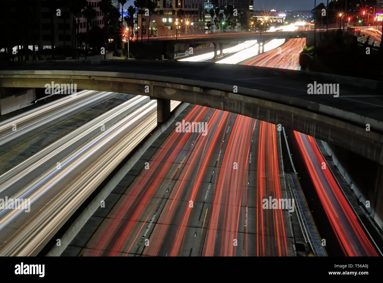 The blurred lights of cars streaming down a freeway at night Stock ...