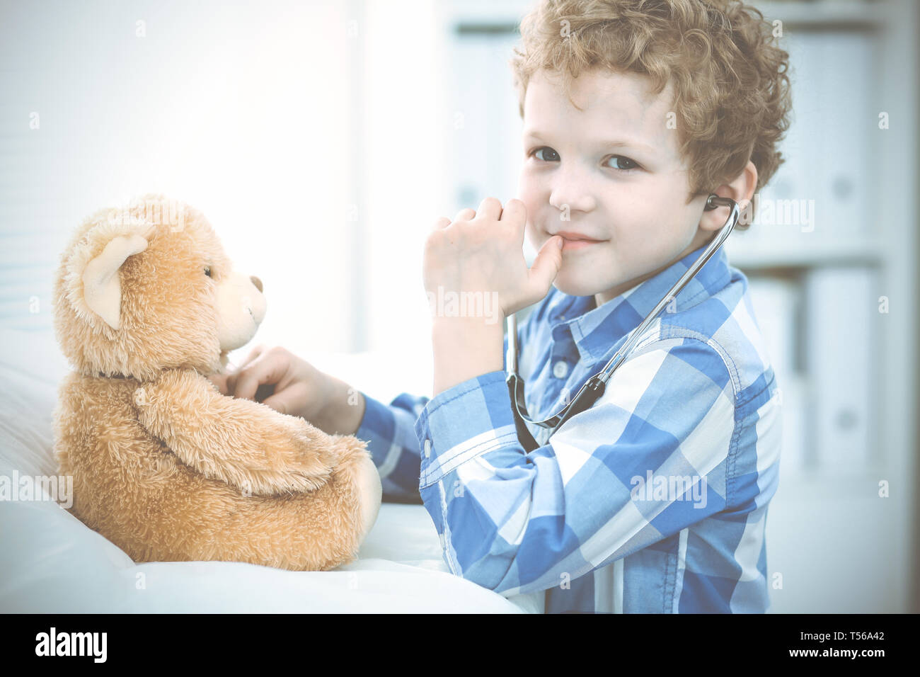 Doctor and patient child. Physician examining little boy. Regular ...
