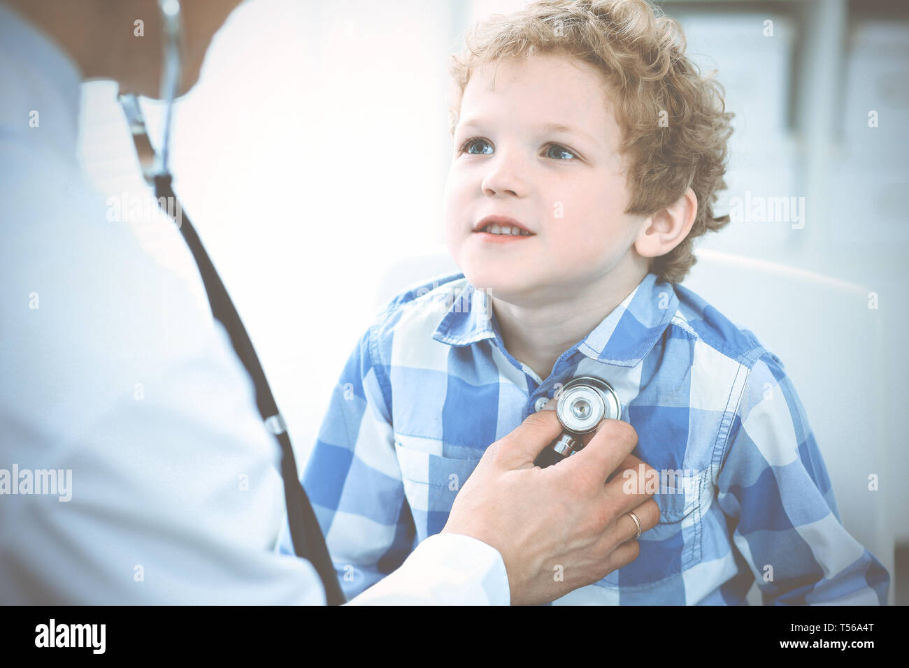 Doctor and patient child. Physician examining little boy. Regular ...