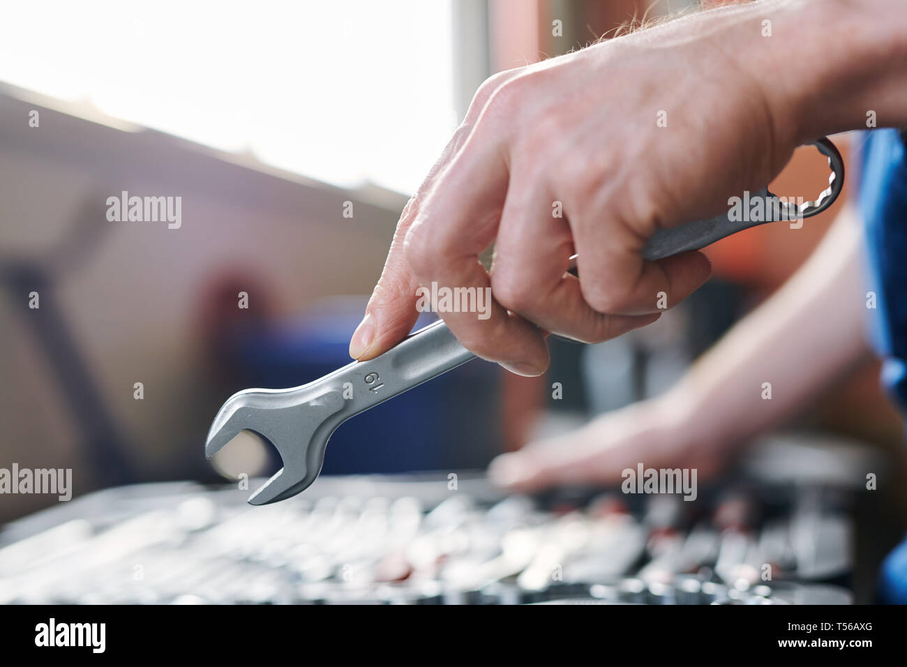 Hand with wrench Stock Photo - Alamy