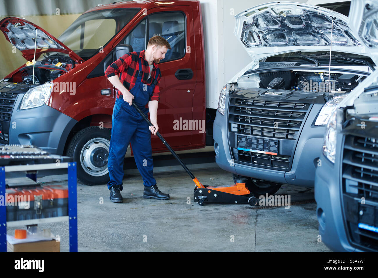 Putting cart under car Stock Photo - Alamy