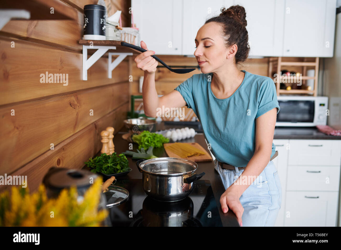 Woman tasting cooking hi-res stock photography and images - Alamy