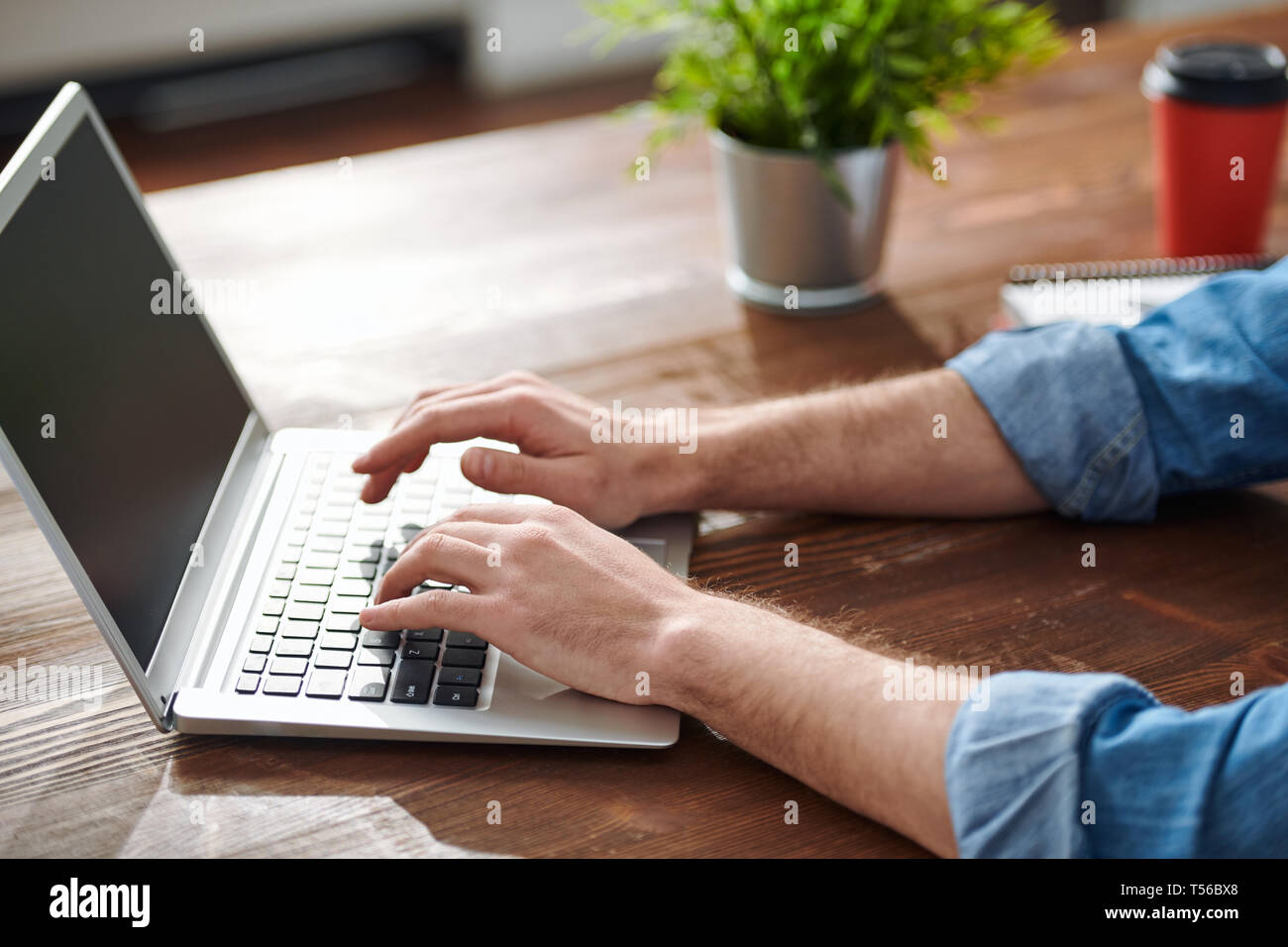 Typing by desk Stock Photo - Alamy