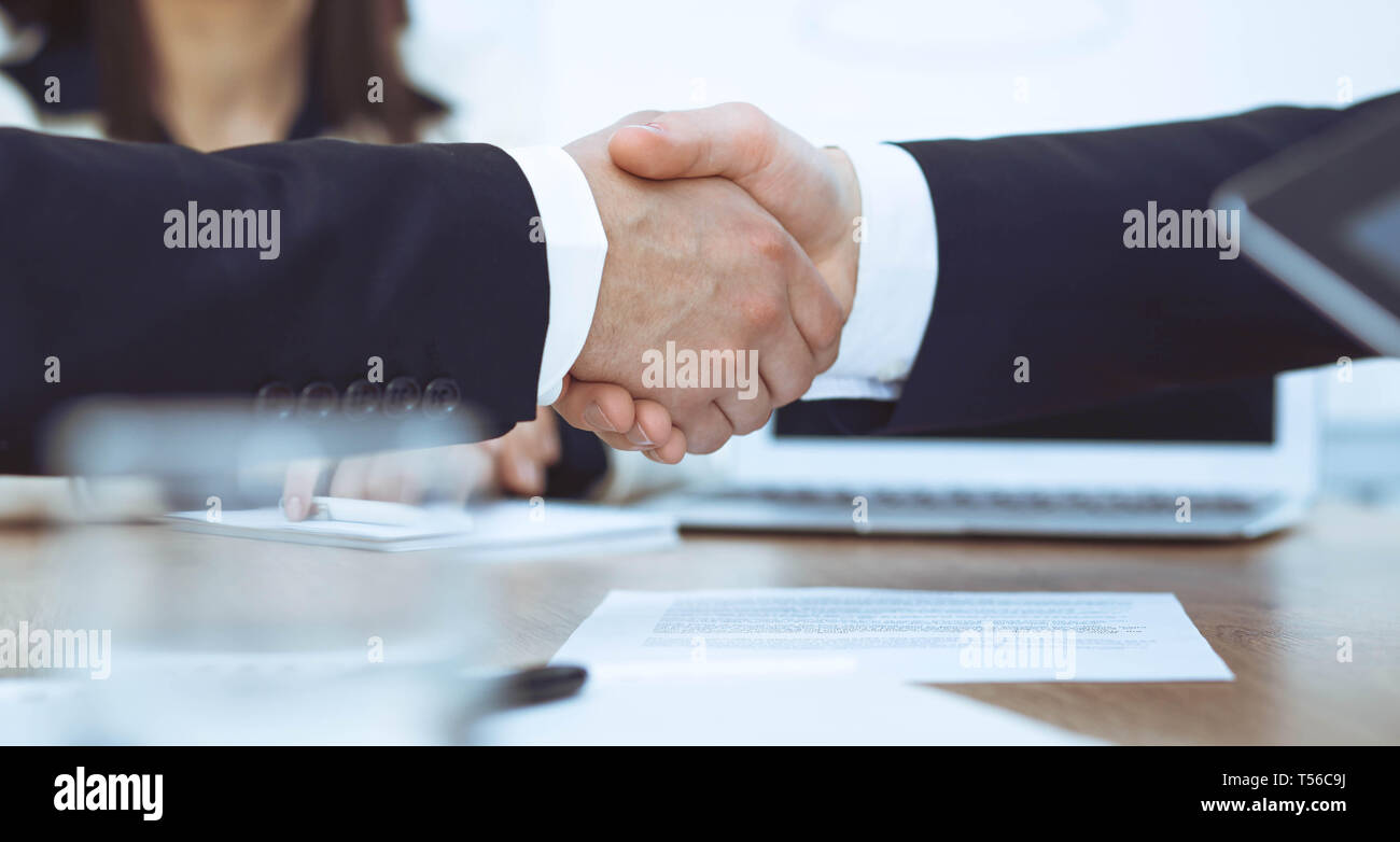 Business people shaking hands at meeting or negotiation in the office ...