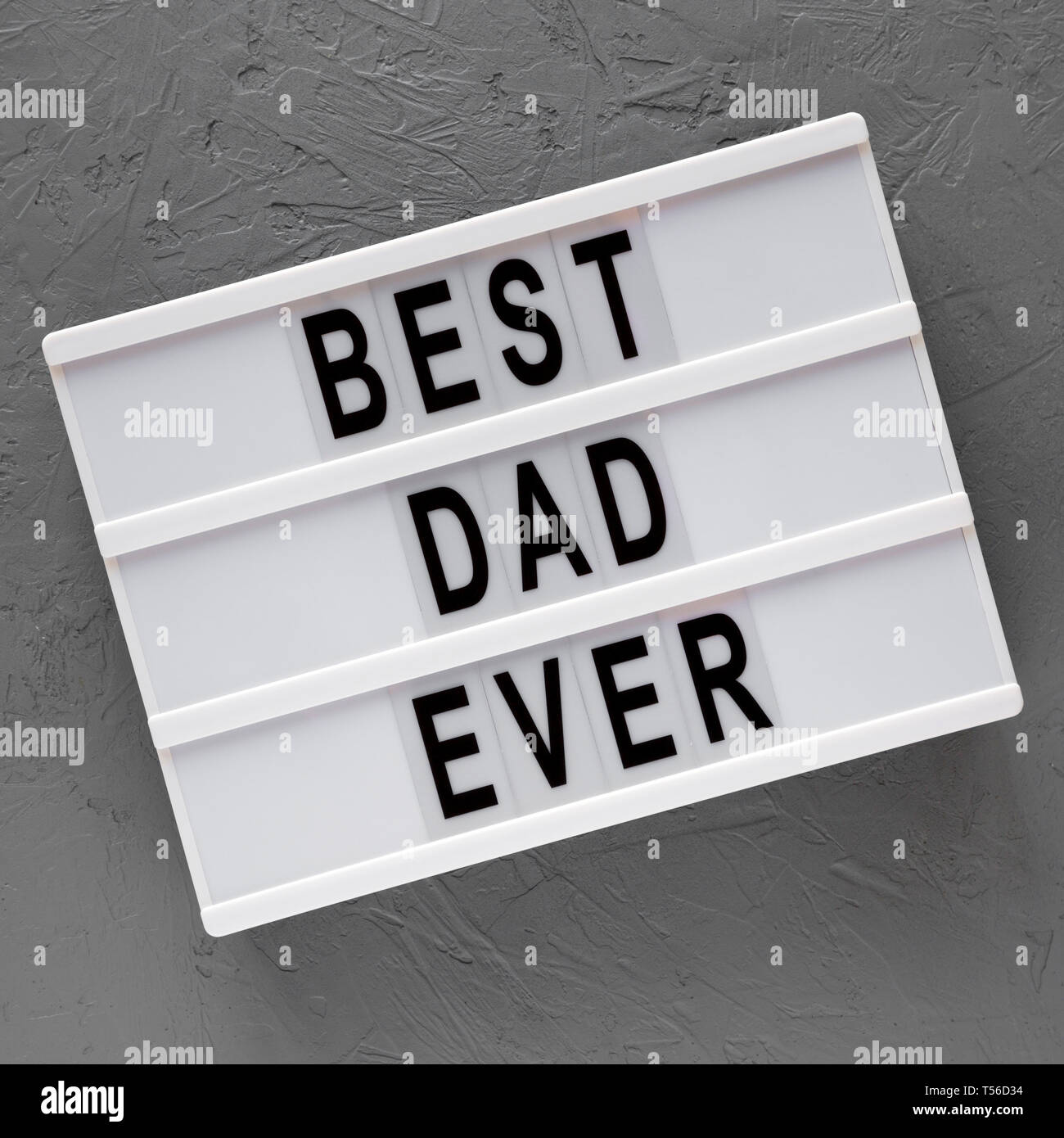 'Best dad ever' words on a lightbox over gray surface, top view ...