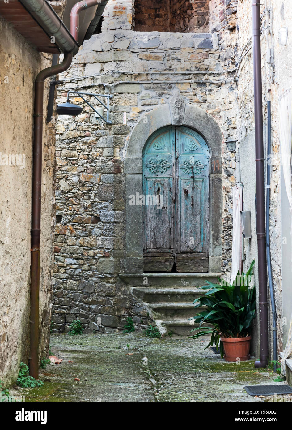 Ancient carved door and stone doorway with carving, in a small village ...
