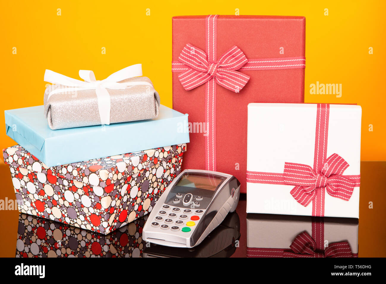 Terminal, boxes with gifts on black glass table and yellow background ...