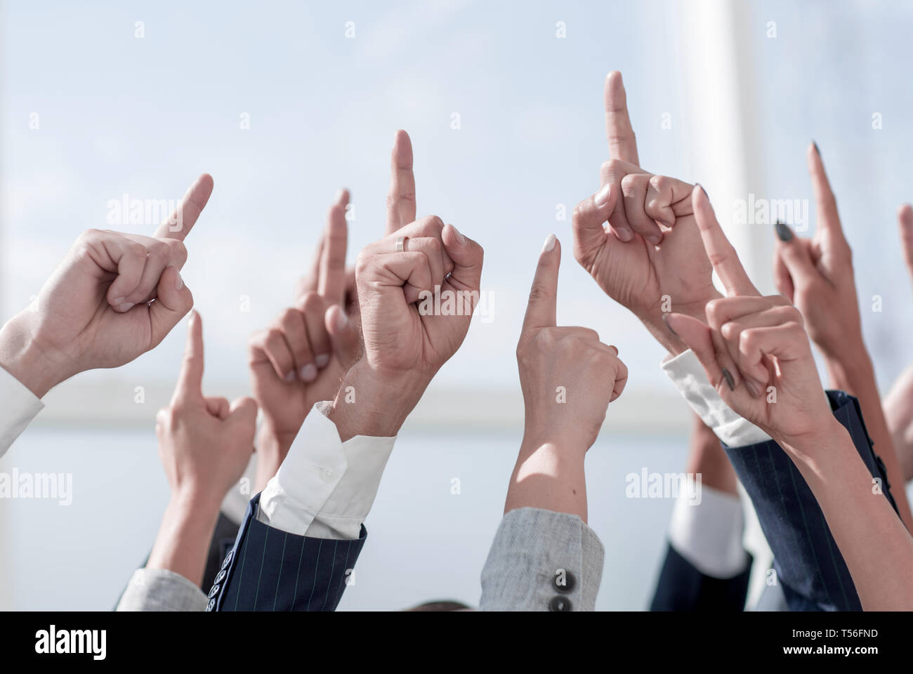 close up. a group of business people pointing up.photo with space for ...