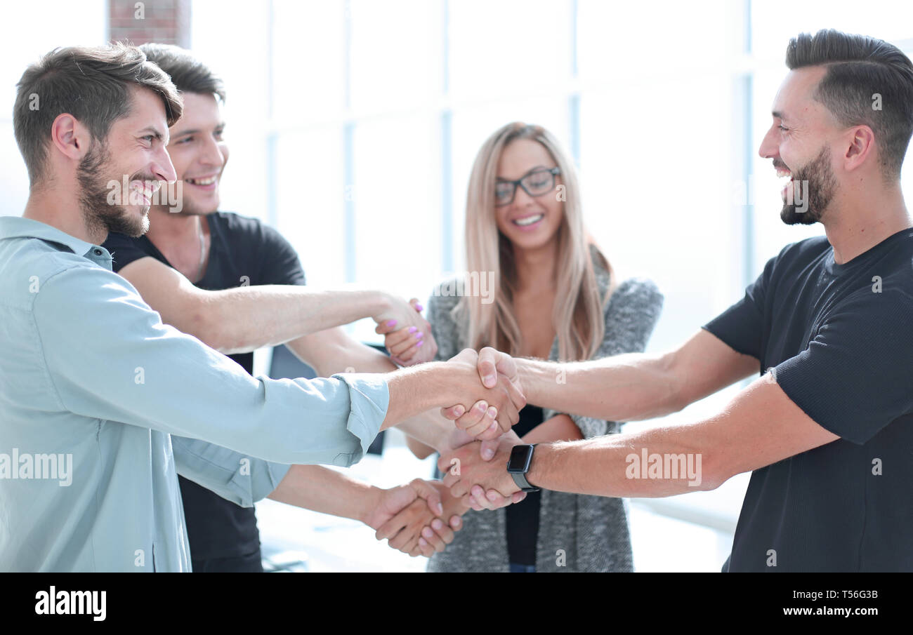 Business people with stacked hands at creative office Stock Photo - Alamy