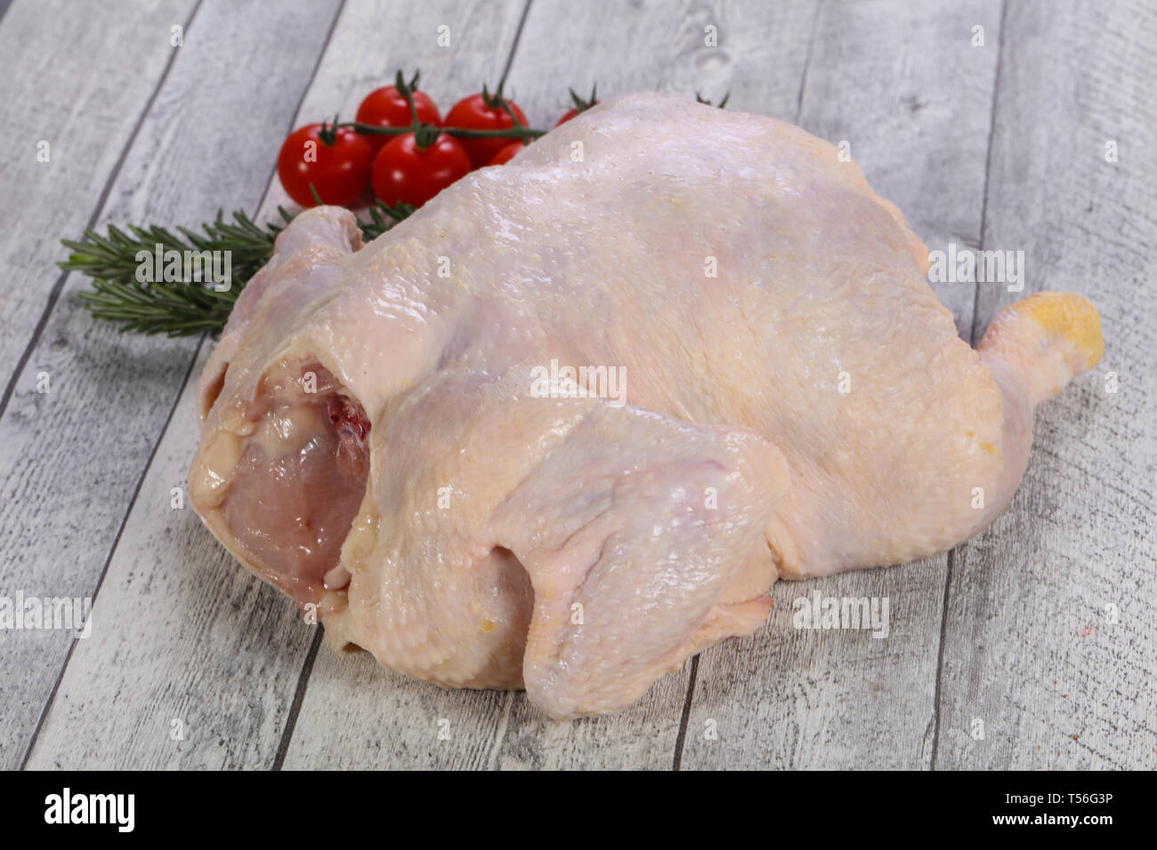 Raw chicken ready for cooking over wooden background Stock Photo - Alamy