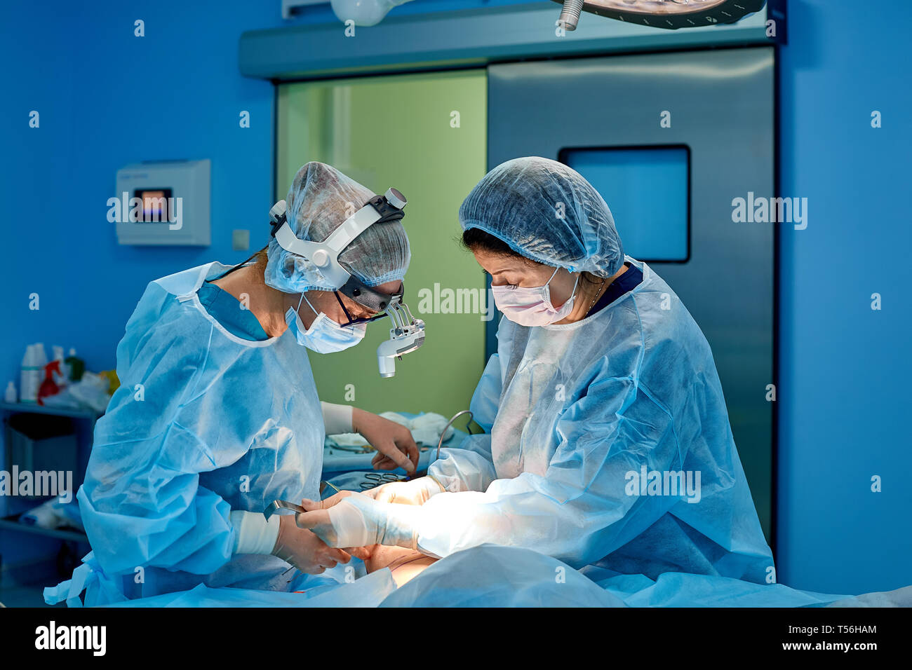 Shot in Operating Room, Assistant Hands out Instruments to Surgeons ...