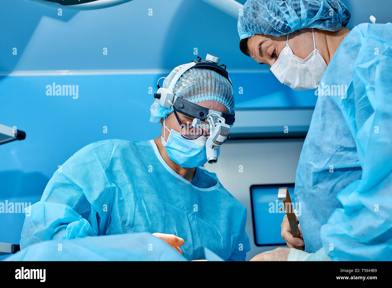 Shot in Operating Room, Assistant Hands out Instruments to Surgeons ...