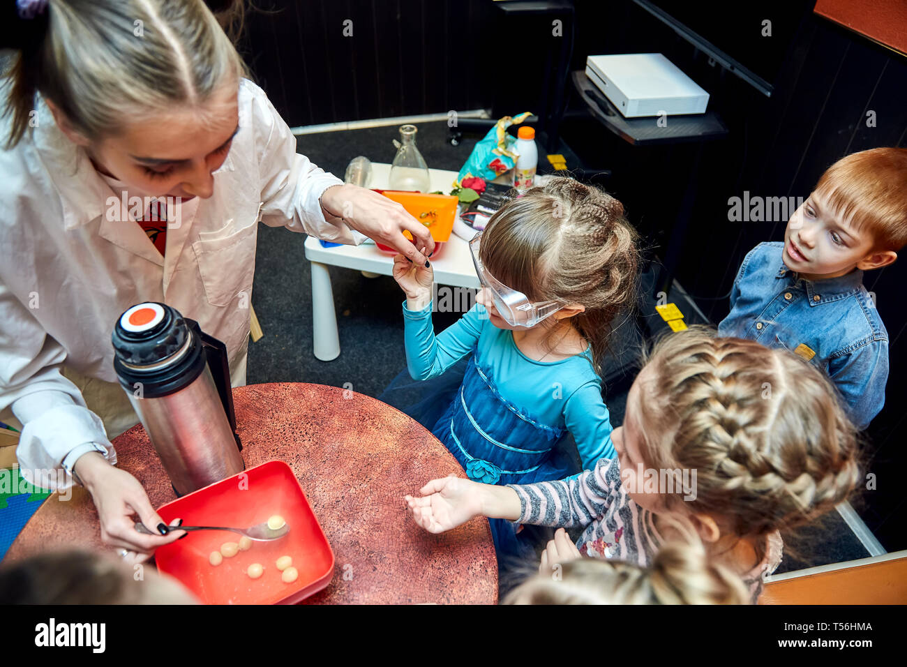 Chemical show for kids. Professor carried out chemical experiments with ...