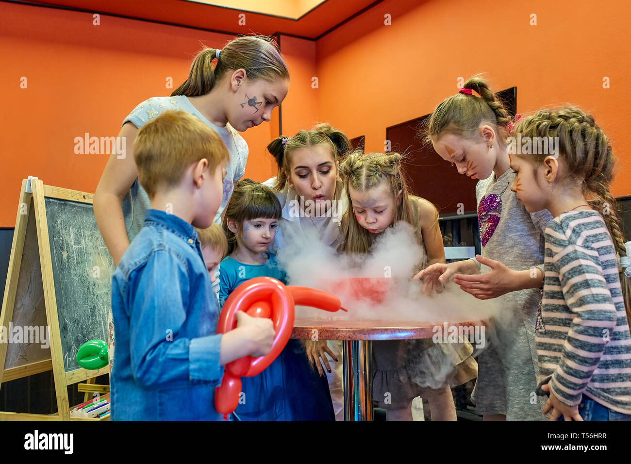 Chemical show for kids. Professor carried out chemical experiments with ...