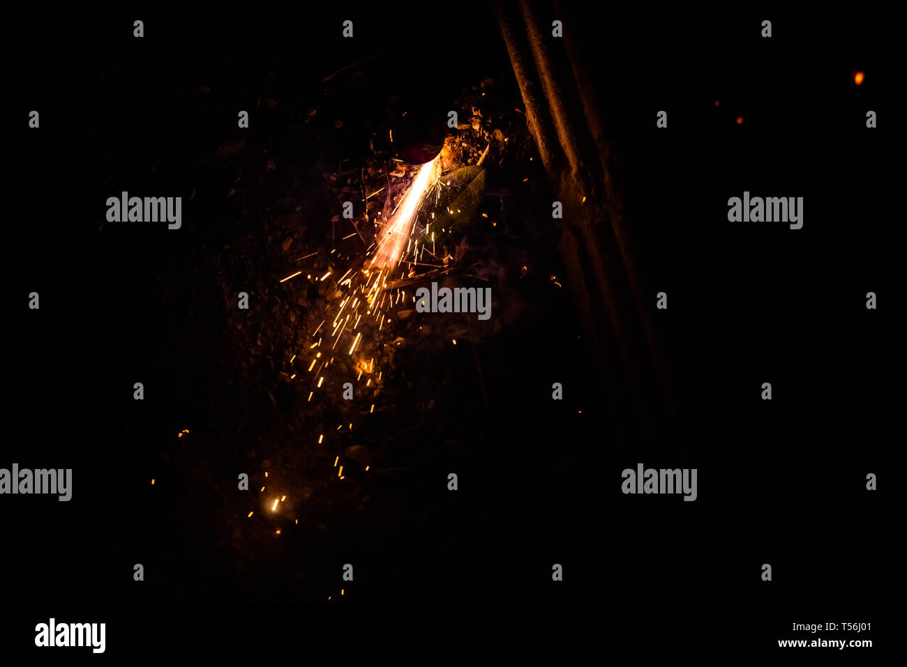 Firecrackers spinning over themselves at night, throwing sparks of fire ...