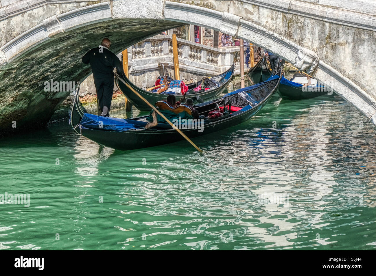 Venice, Italy - April 17 2019: Gondola passing below one of many ...