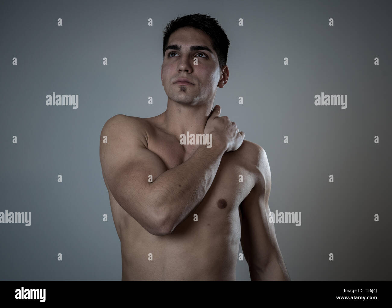 Young muscular fit man touching and grabbing neck and upper back ...