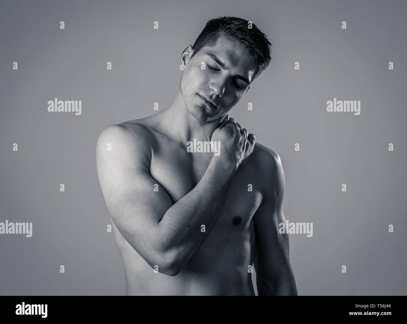 Young muscular fit man touching and grabbing neck and upper back ...