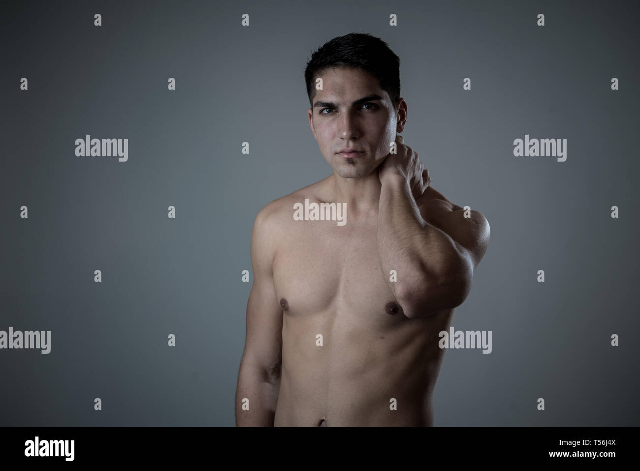 Young muscular fit man touching and grabbing neck and upper back ...