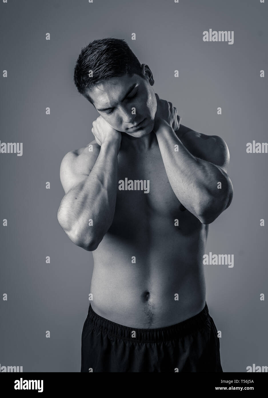 Young muscular fit man touching and grabbing neck and upper back ...