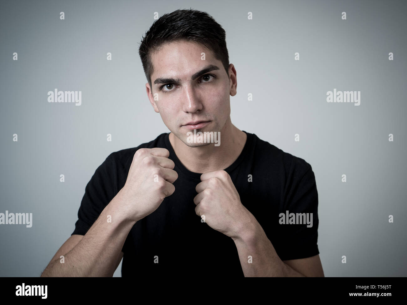 Close up portrait of an attractive young man with angry face looking ...