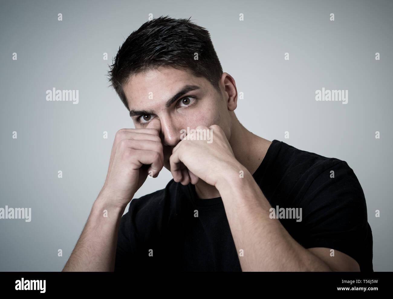 Close up portrait of an attractive young man with angry face looking ...