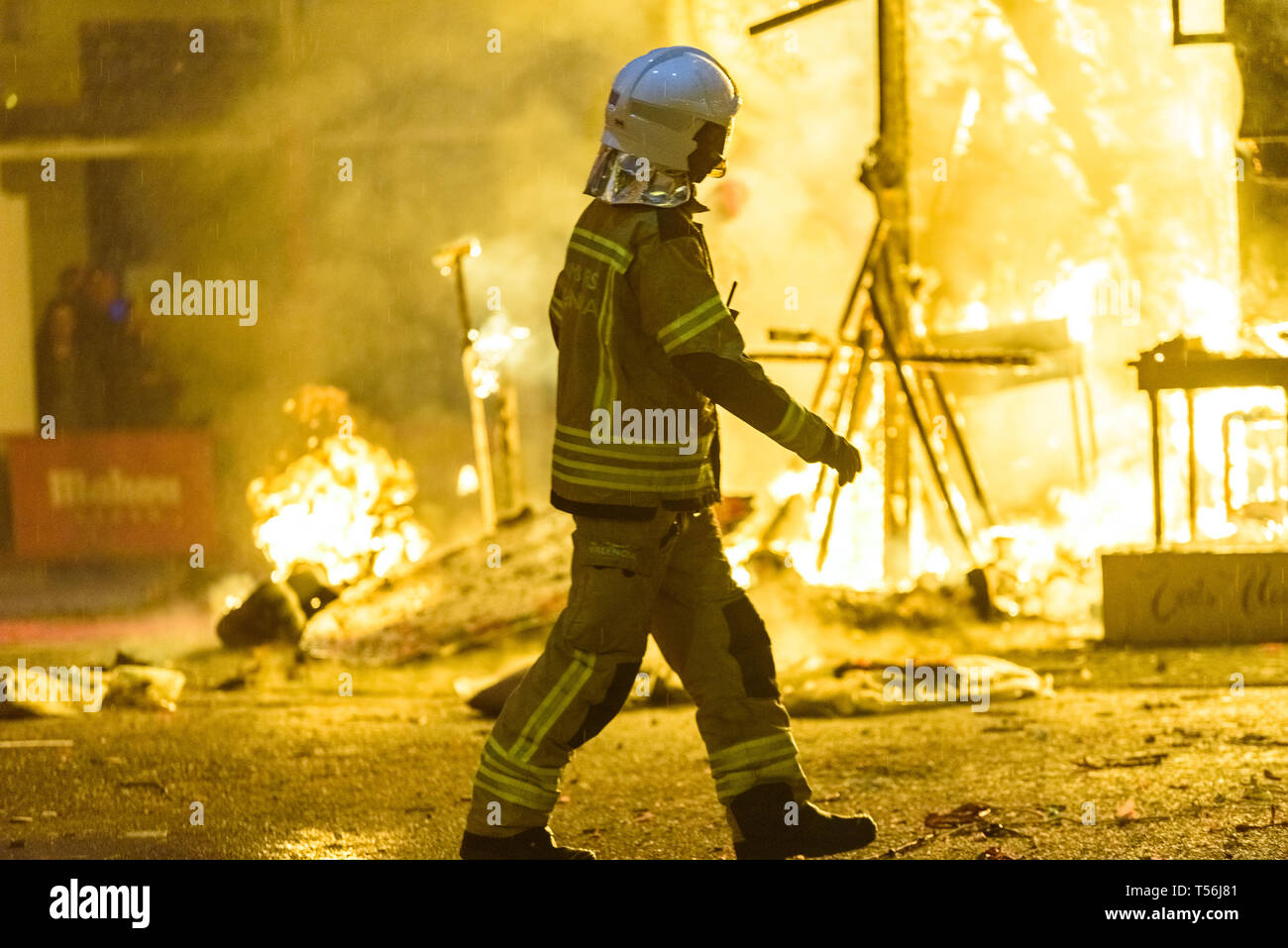 Firemen around a bonfire caused by a Falla Valenciana controlling the ...