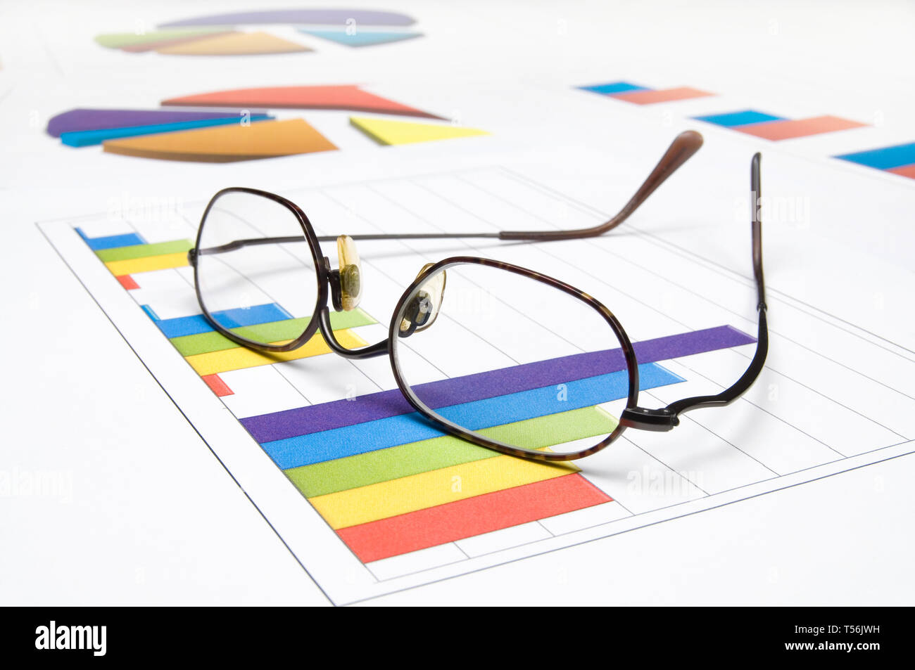 Business Still Life with Eyeglasses and Financial Graphs Stock Photo ...
