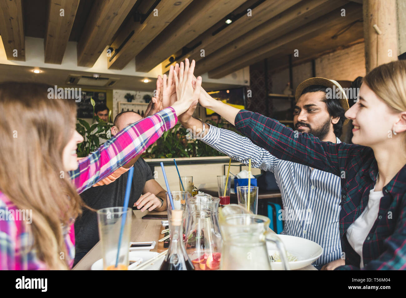 Meet young attractive people in the cafe. Friends chat, have fun, drink ...