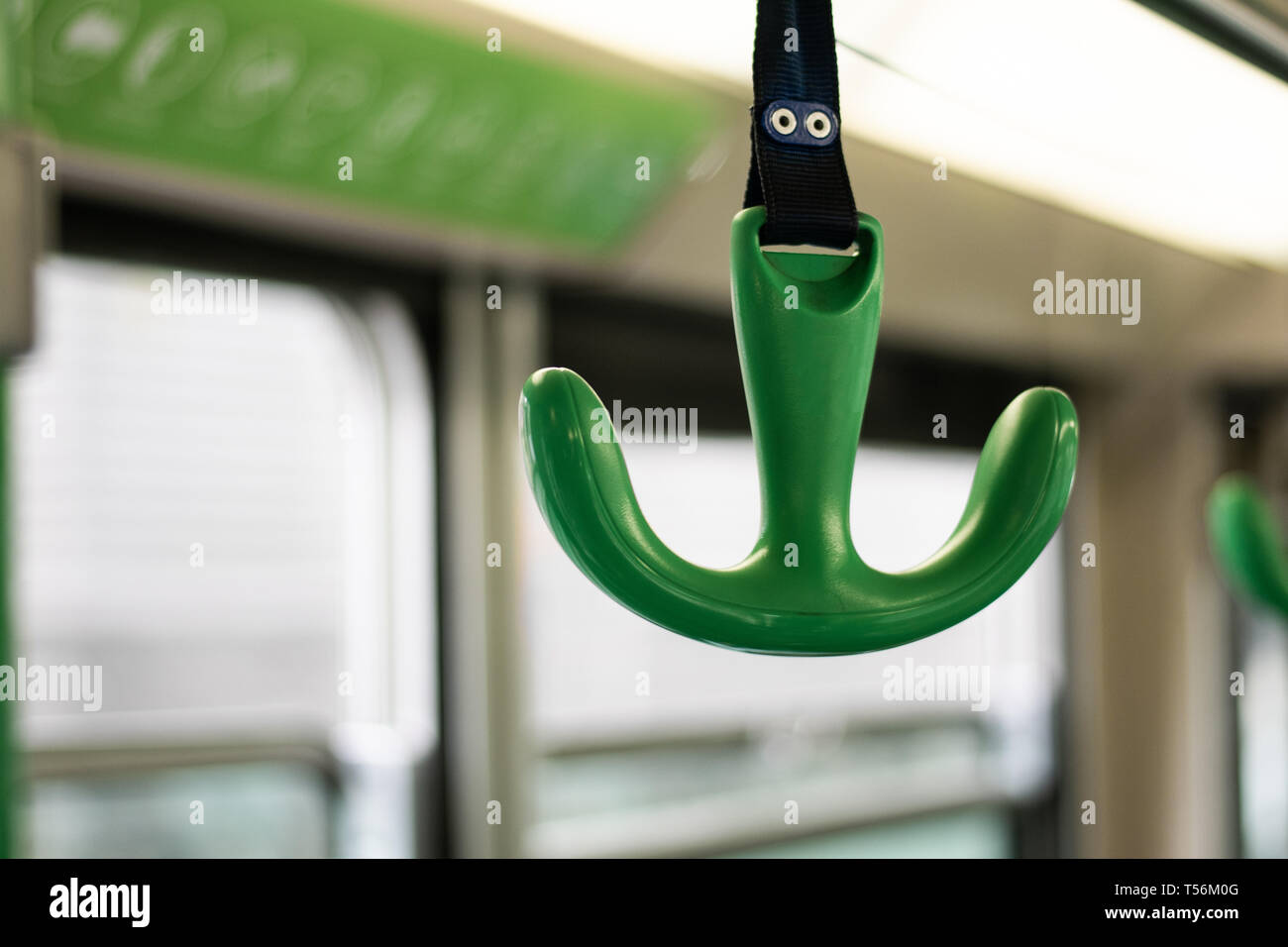 Green bus handle strap on morning commute to work in the city Stock ...