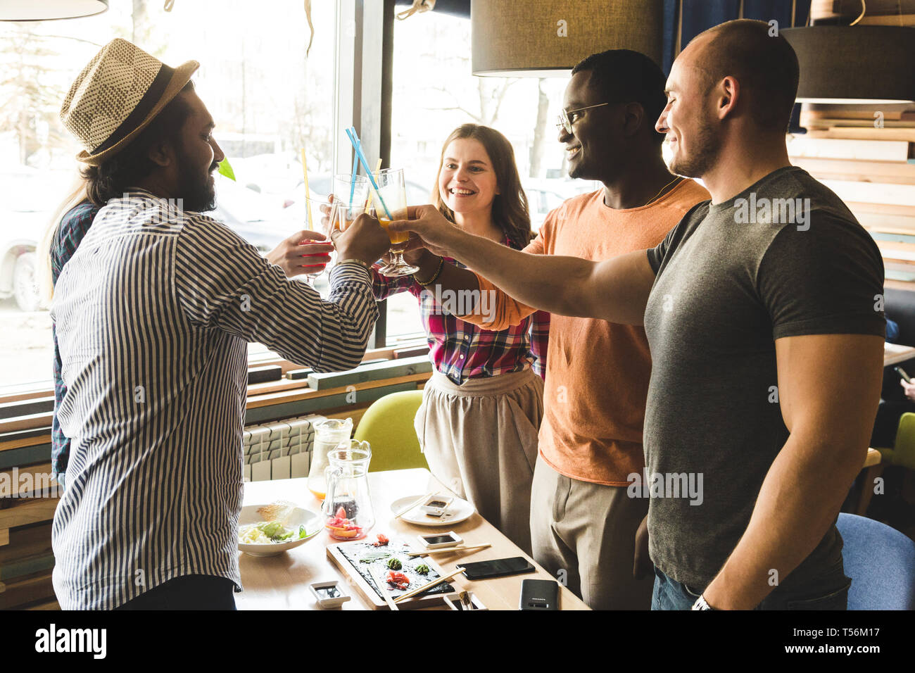 Meet young attractive people in the cafe. Friends chat, have fun, drink ...