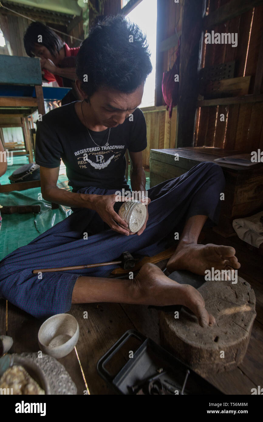 Young silversmith making a silver bowl to sell to tourists on Inle Lake ...