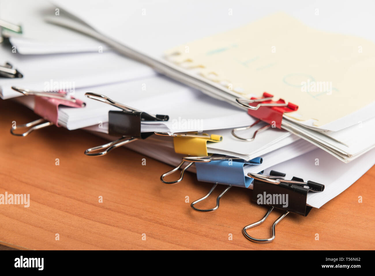 Paper business documents of unfinished stacked on office desk archive ...