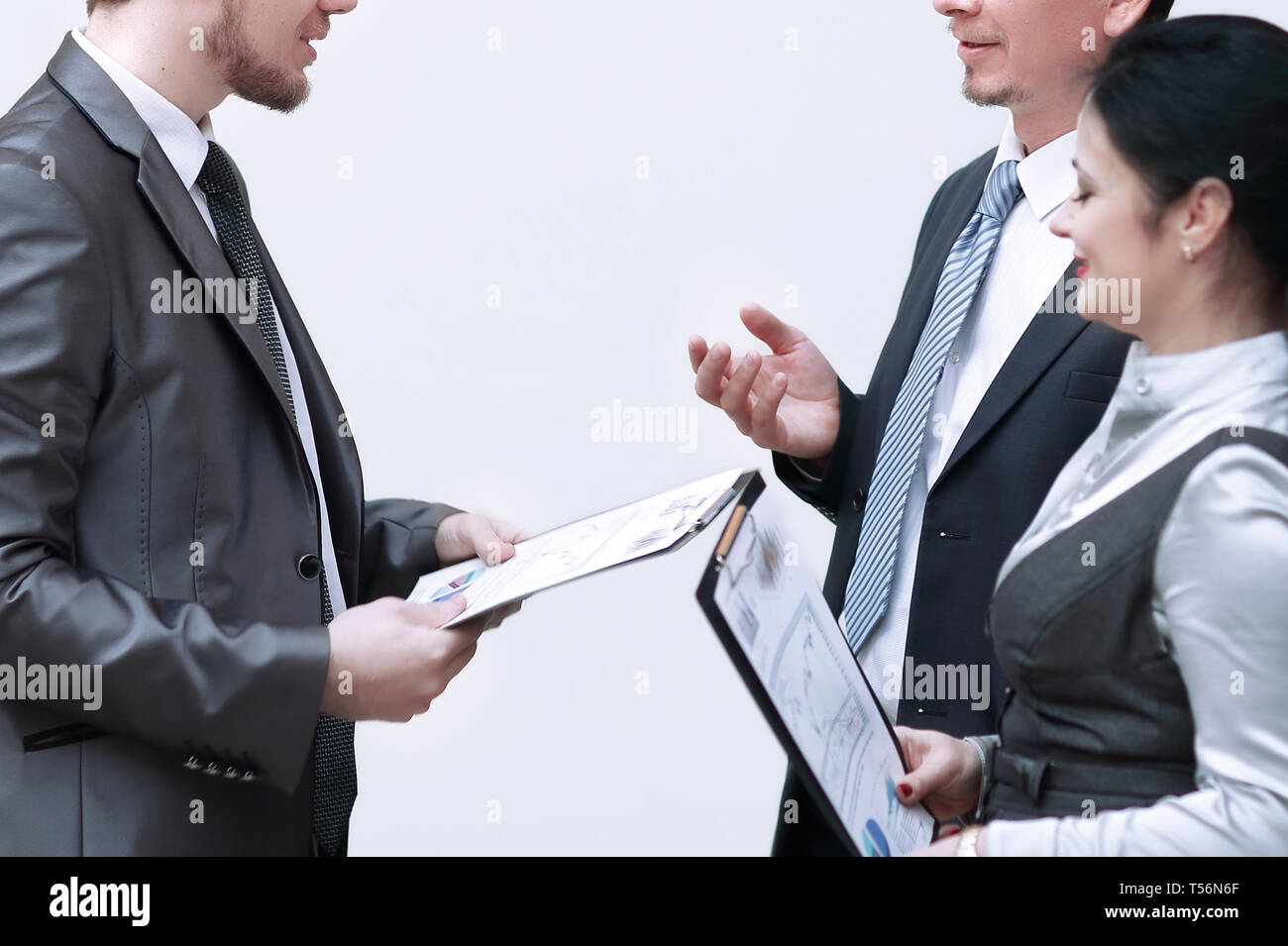 staff discuss business documents,standing in the lobby of the office ...
