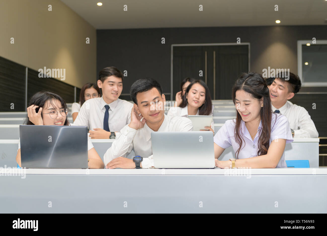 Group of students working with laptop in classroom at university ...