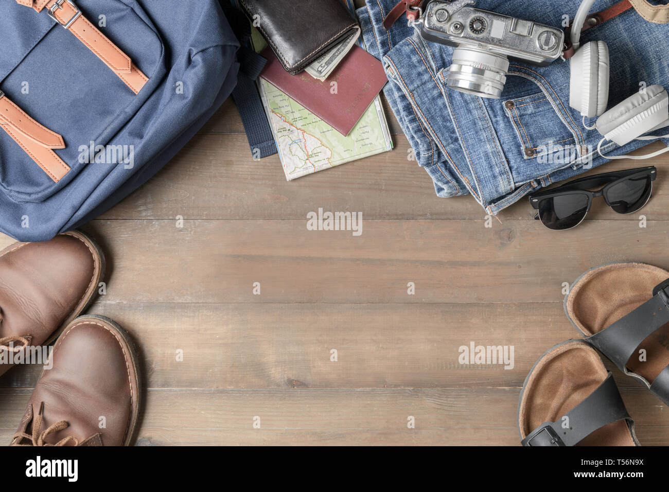 prepare backpack accessories and travel items on wood background with ...