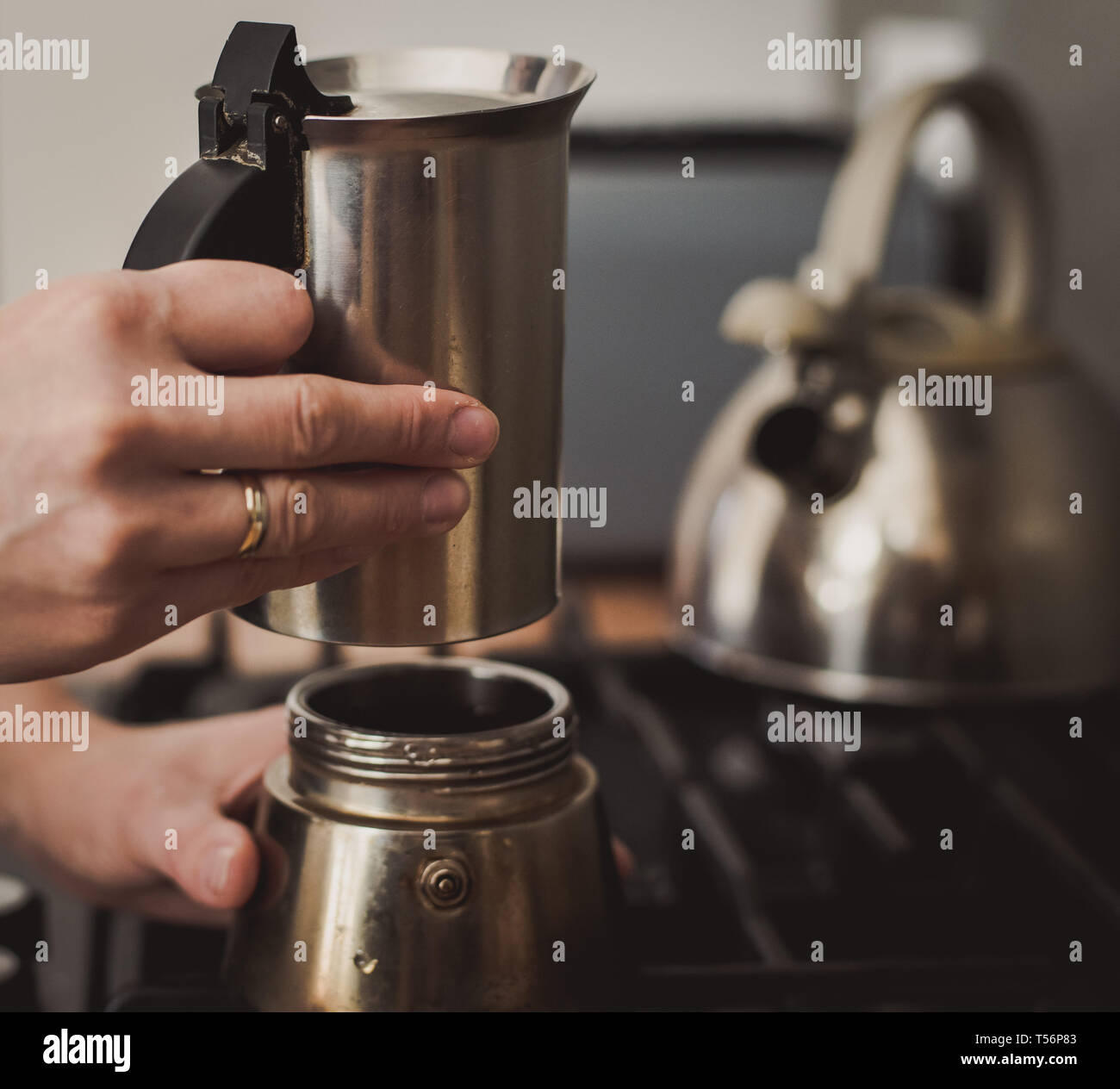 Preparing a traditional italian style coffee with coffee percolator ...