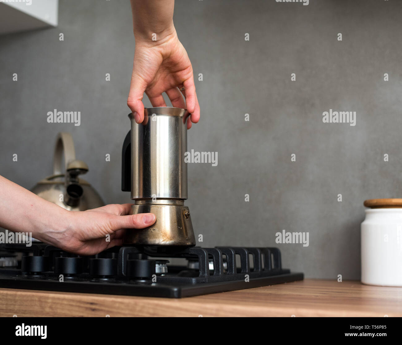 Preparing a traditional italian style coffee with coffee percolator ...