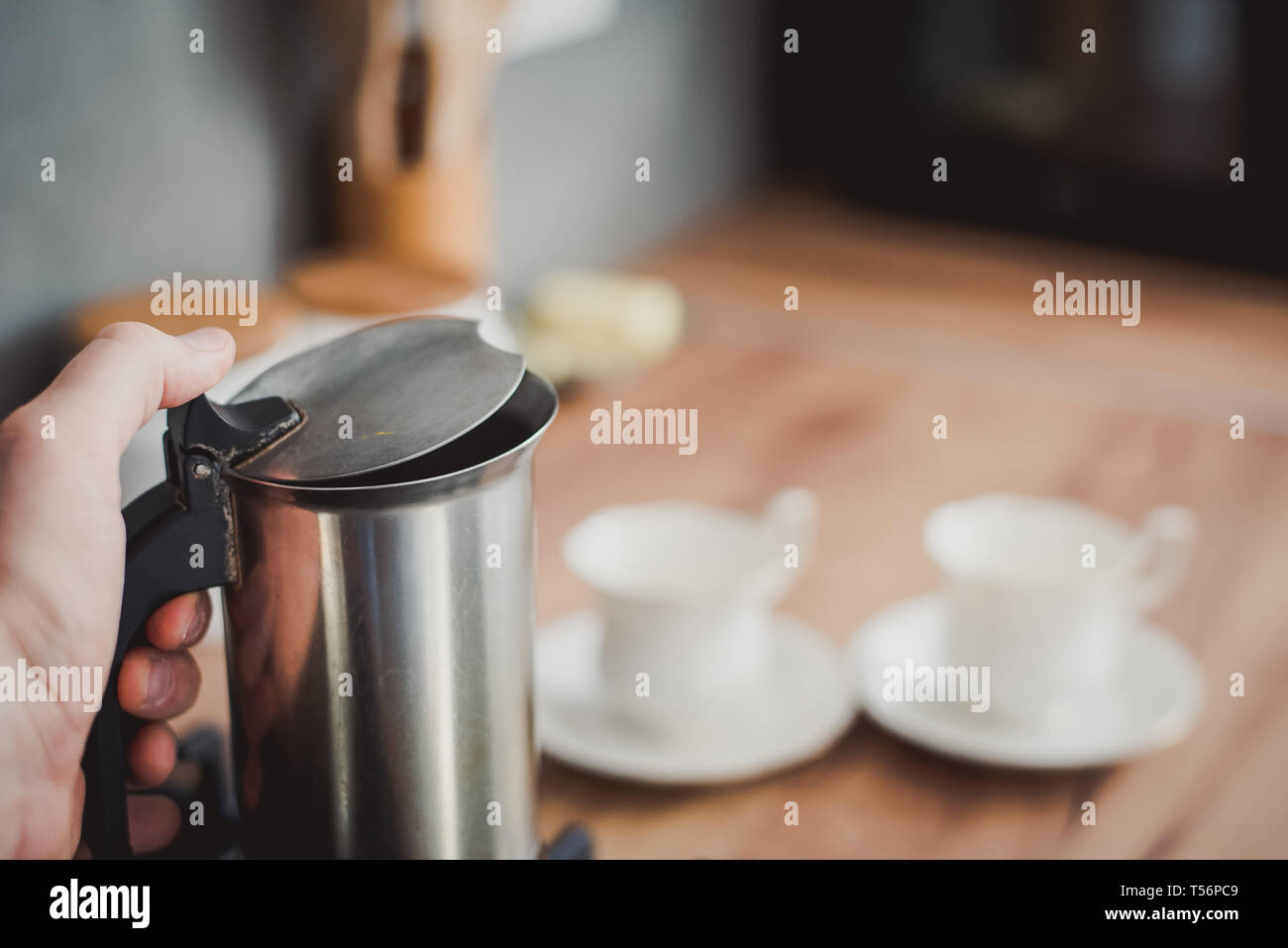 Preparing a traditional italian style coffee with coffee percolator ...