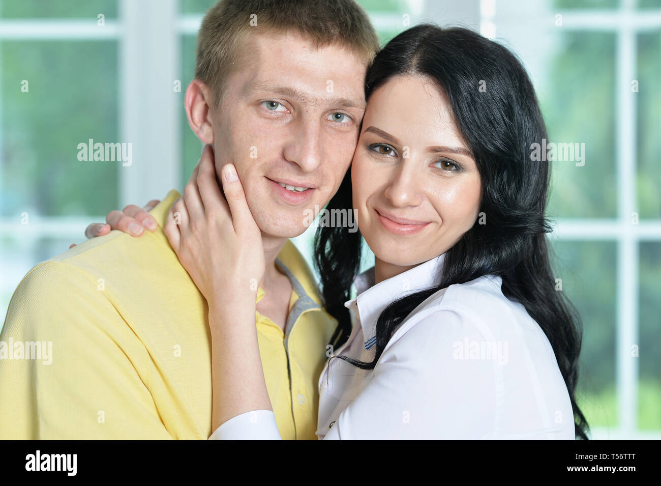 Portrait of pretty couple posing at home Stock Photo - Alamy
