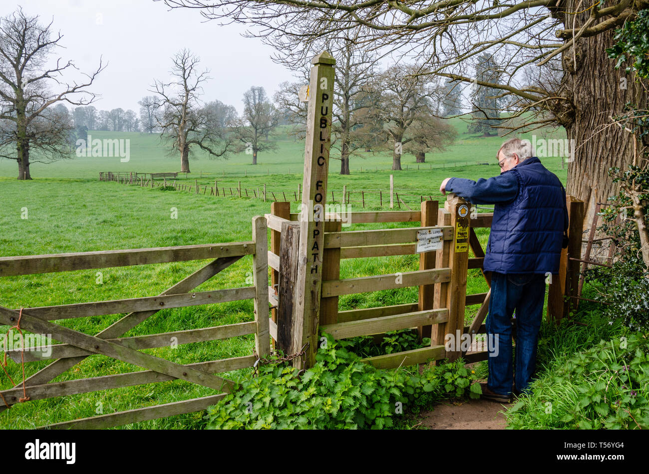 A man passes through a kissing gate to walk along a public footpath ...