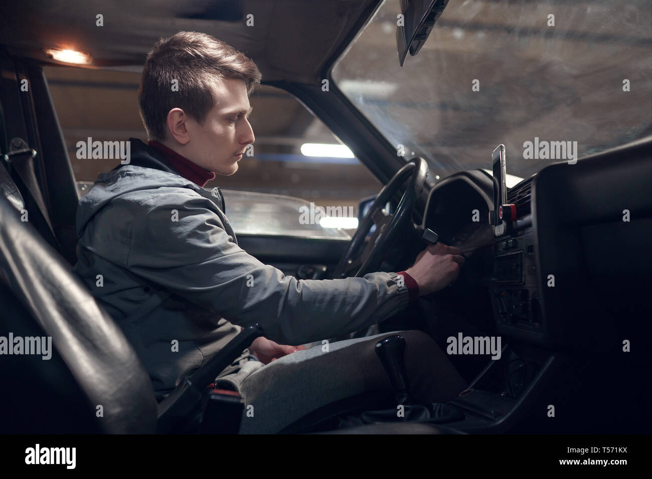 Photo from side of man sitting in car Stock Photo - Alamy