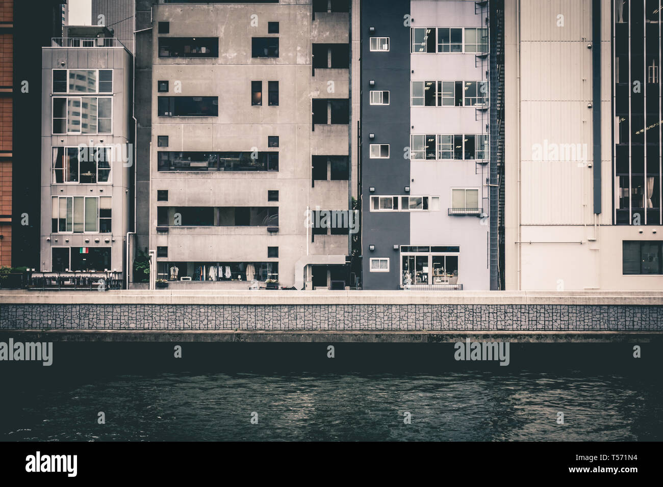 front view Modern business building with city river Stock Photo - Alamy