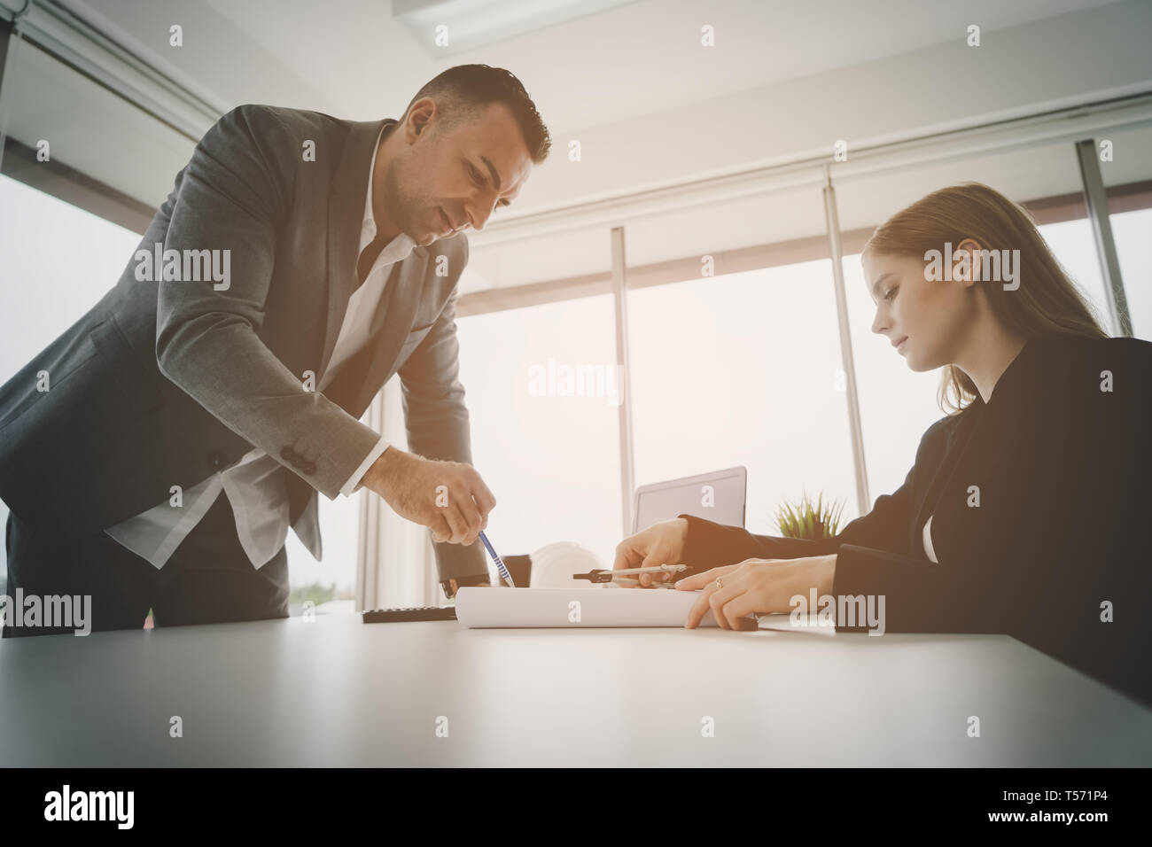 Female architect is showing her boss the real estate building plan ...
