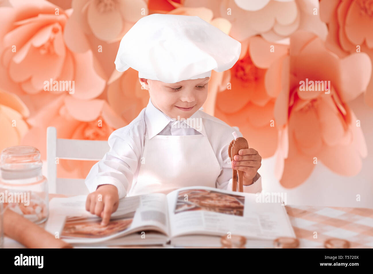 happy boy chef chooses a cooking recipe. the concept of a hobby Stock ...