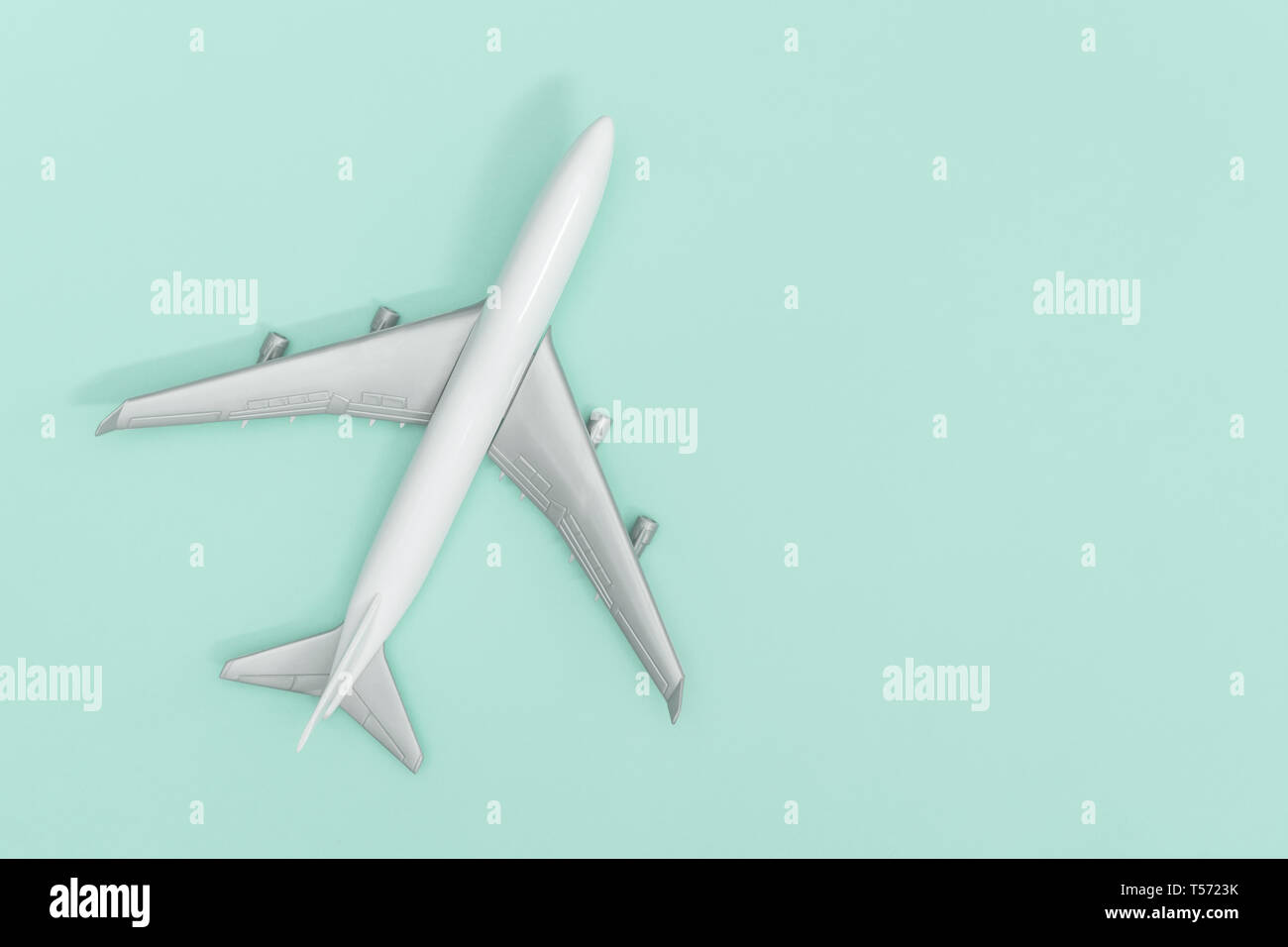white plastic toy plane isolated on blue teal Stock Photo - Alamy