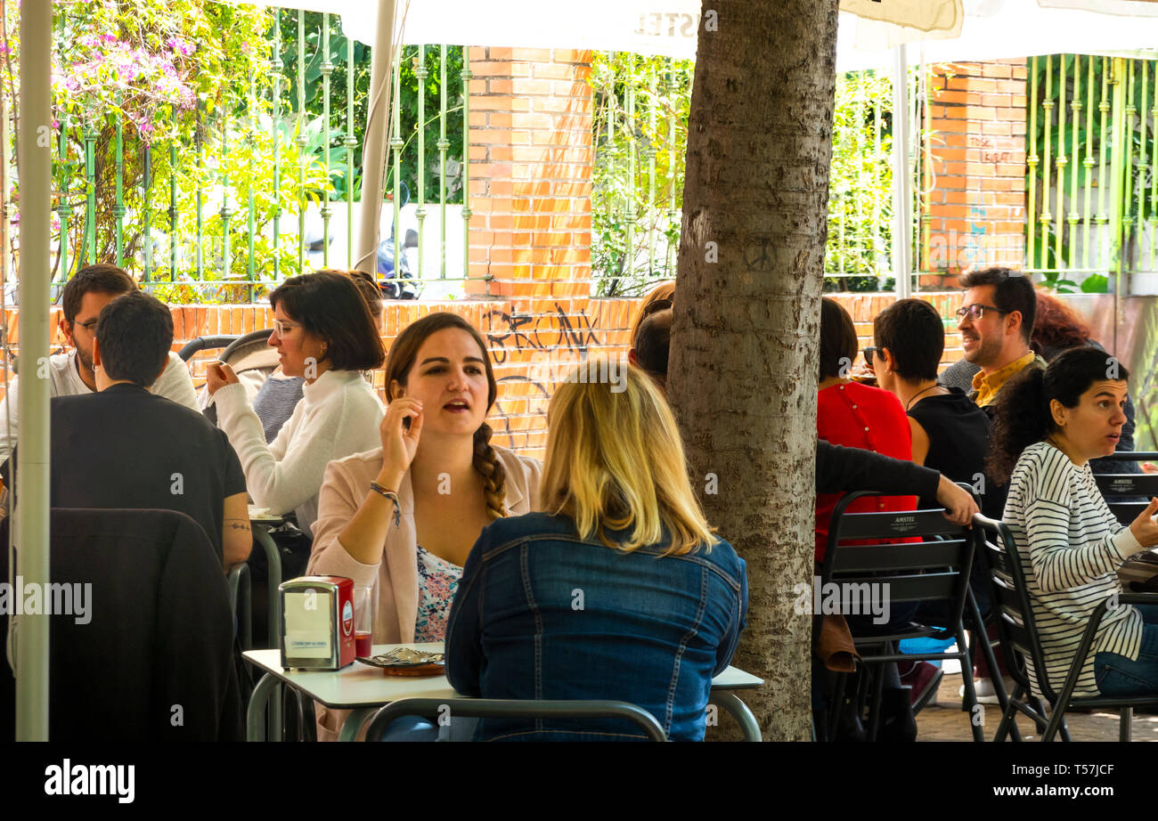 Young women having a talk at a cafe in Seville Stock Photo - Alamy