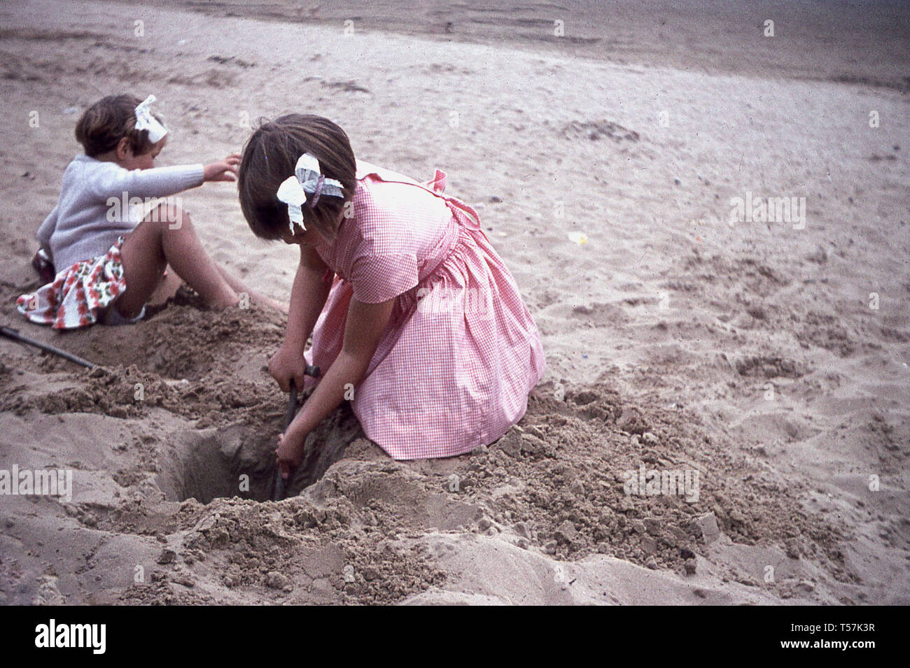 Child digging in the sand with spade hi-res stock photography and ...