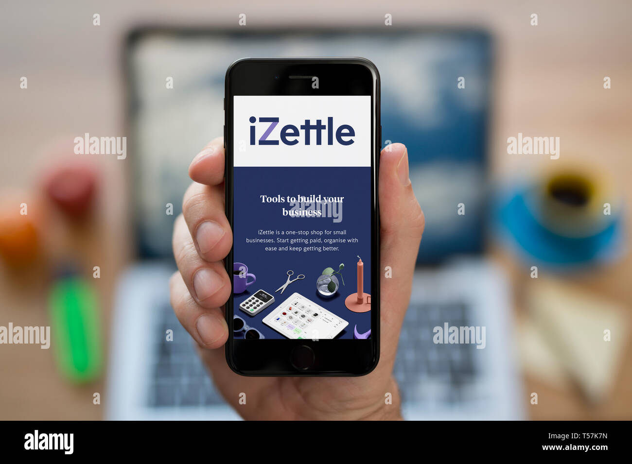 A man looks at his iPhone which displays the iZettle logo (Editorial ...